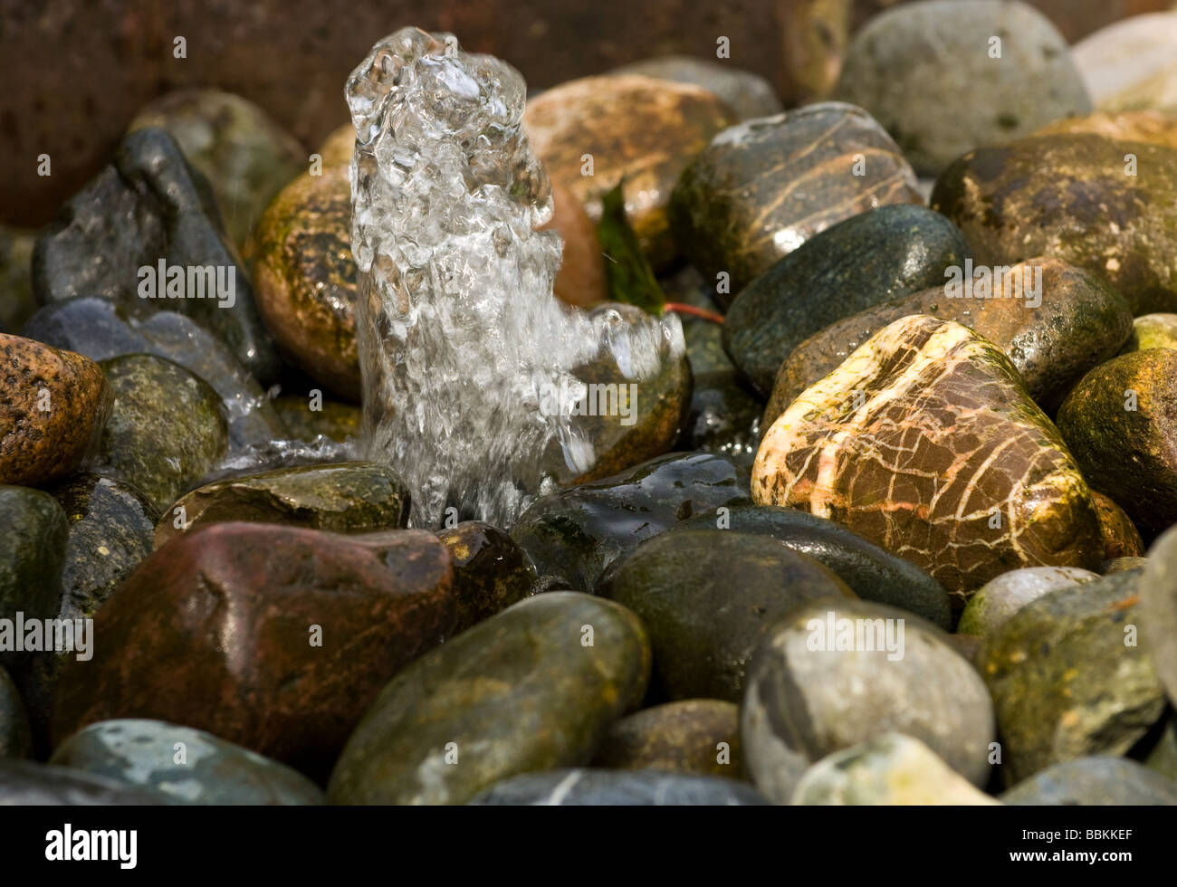 Water Fountain Over Pebbles Stock Photo - Alamy