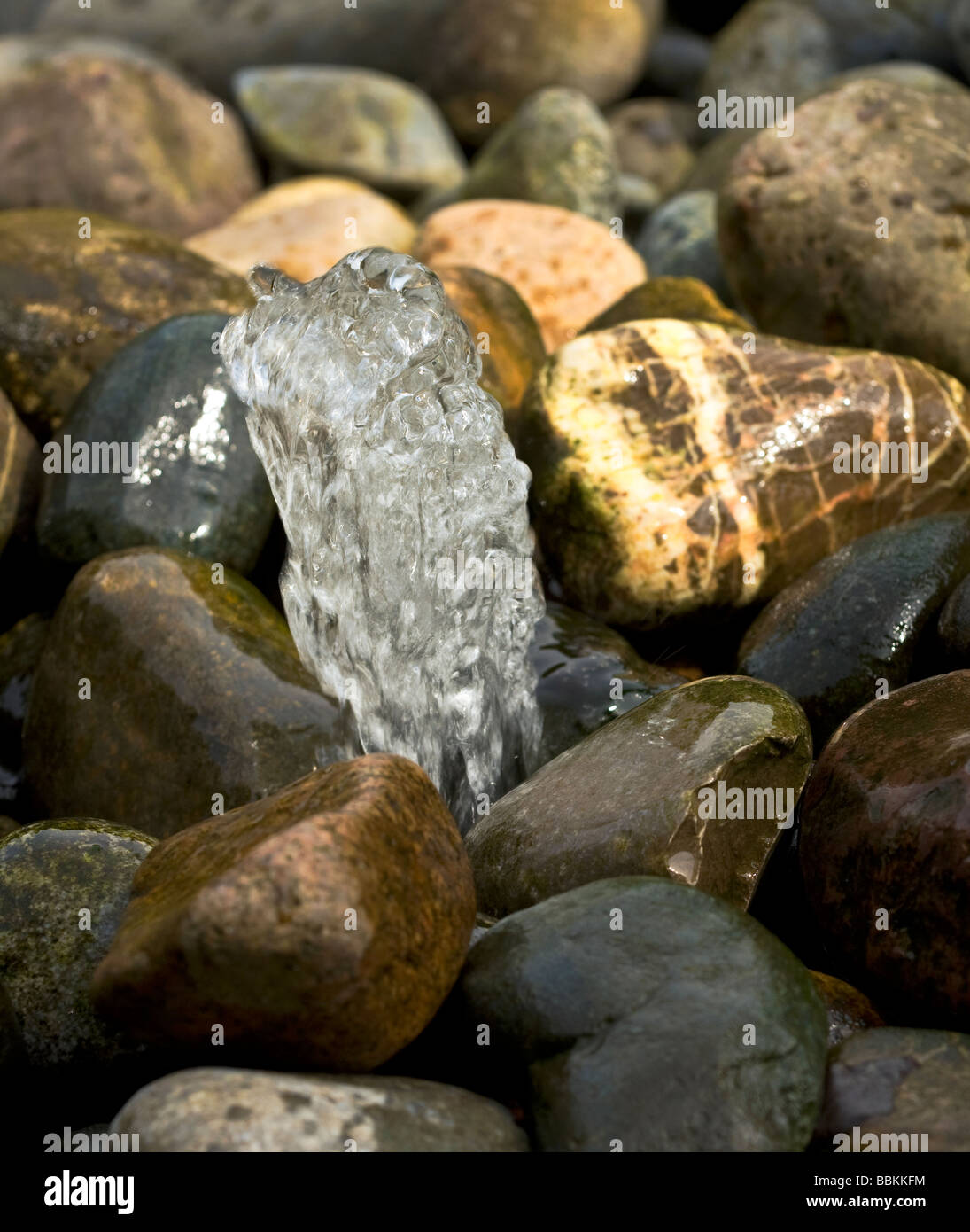 Water Fountain Over Pebbles Stock Photo - Alamy
