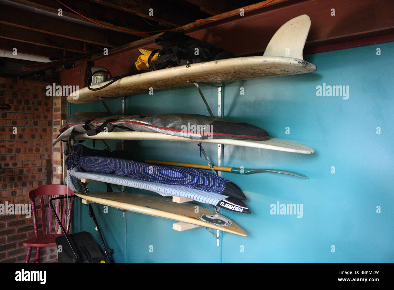 SURFBOARD RACK ON BLUE WALL IN GARAGE HORIZONTAL BDB11194 Stock Photo ...