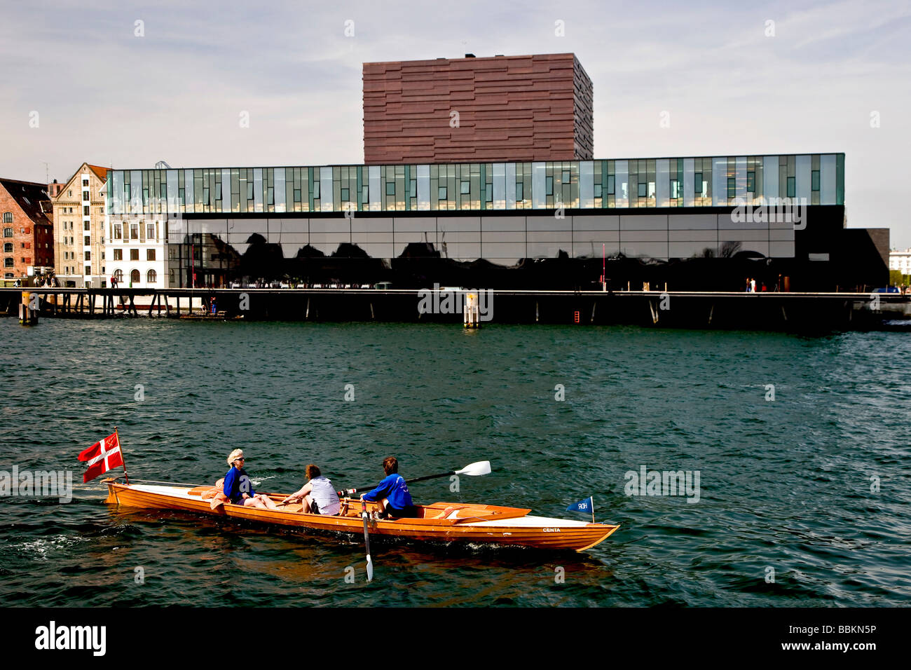 Three ladies in a rowing boat in front of the Royal Danish Playhouse ...