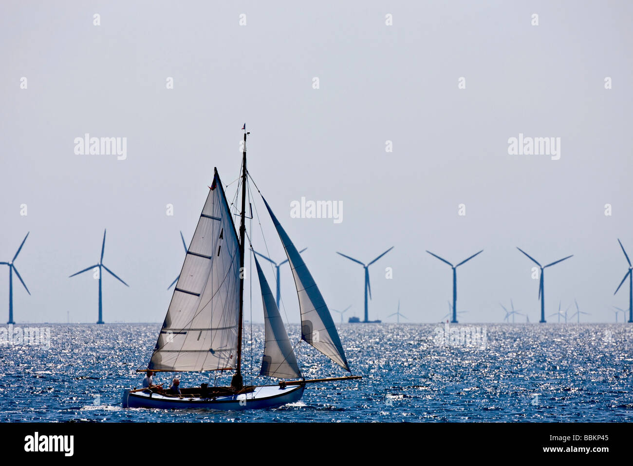 Sailing boat in front of an off shore wind park in the Sound between ...