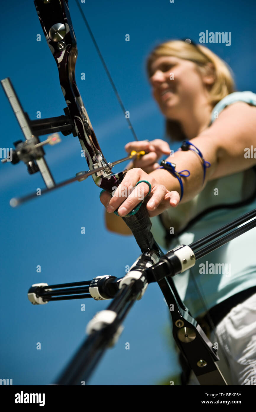 Girl preparing to shoot arrow Stock Photo - Alamy