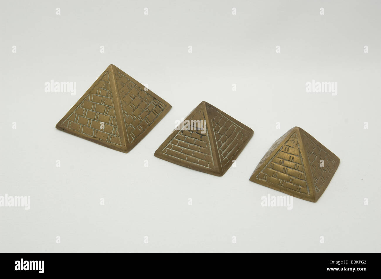 Metal pyramids photographed against a white background Stock Photo - Alamy