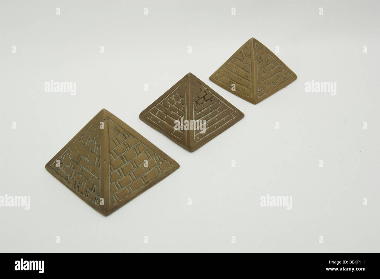 Metal pyramids photographed against a white background Stock Photo - Alamy