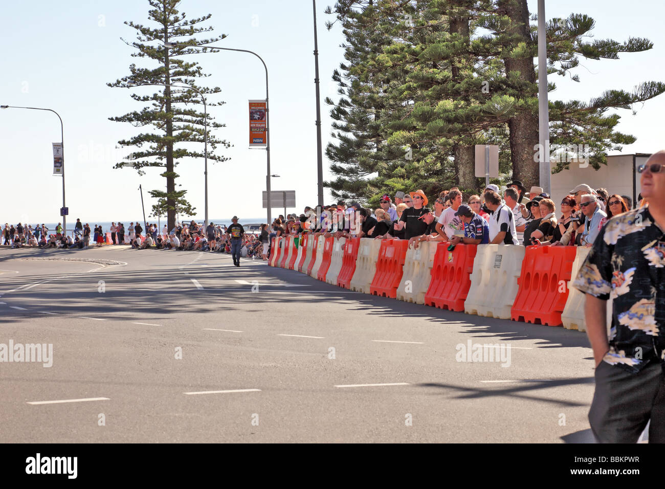 Crowds line a street waiting for a parade Stock Photo - Alamy