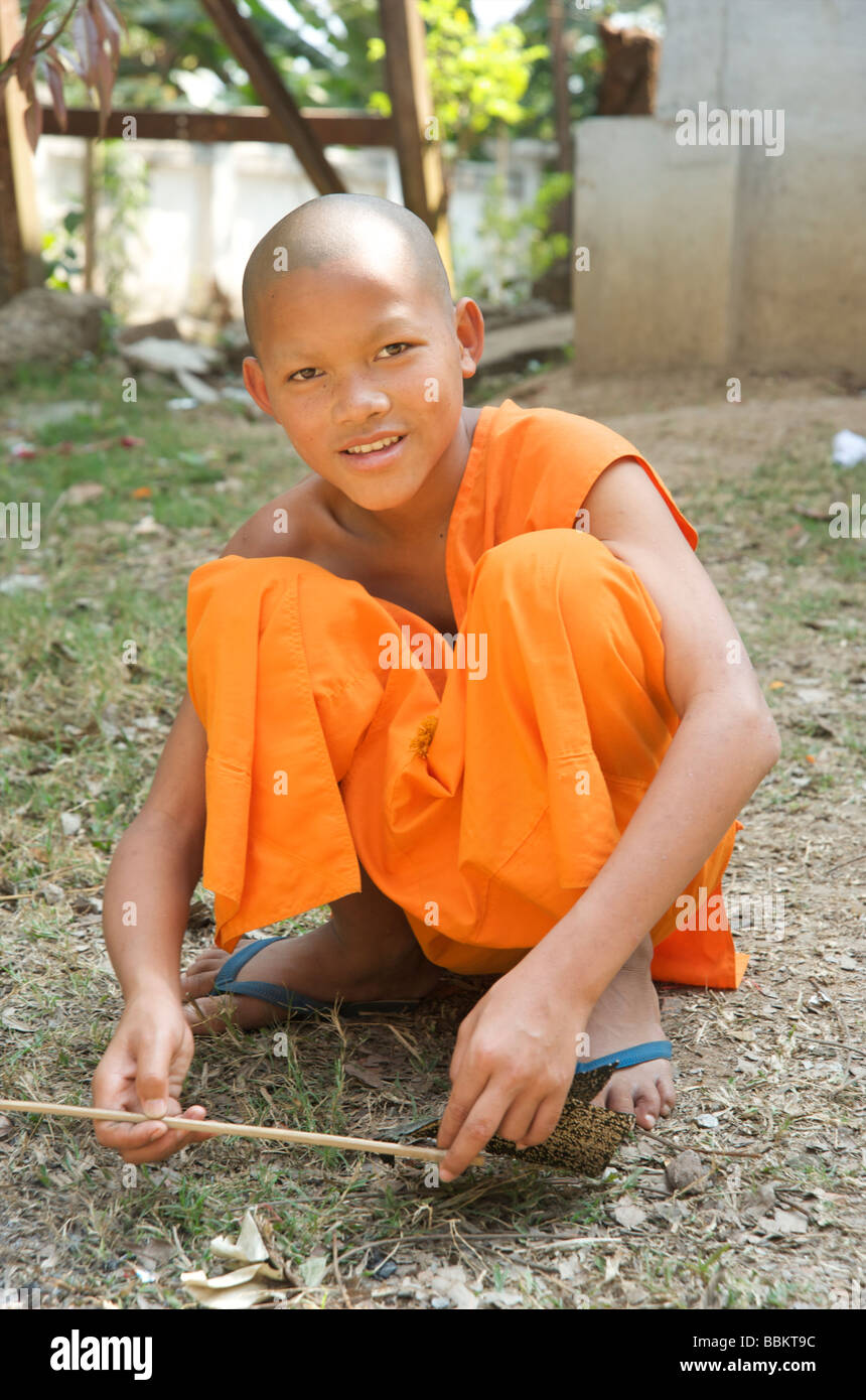 Novice monk sitting by temple hi-res stock photography and images - Alamy