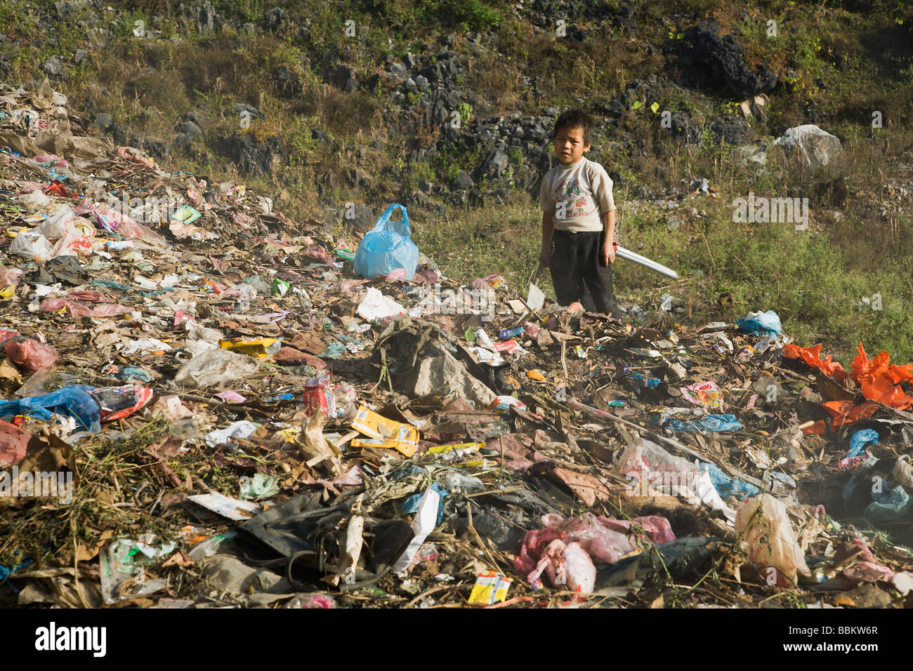 Poor child sorting through garbage from Yen Minh in search of valuables ...