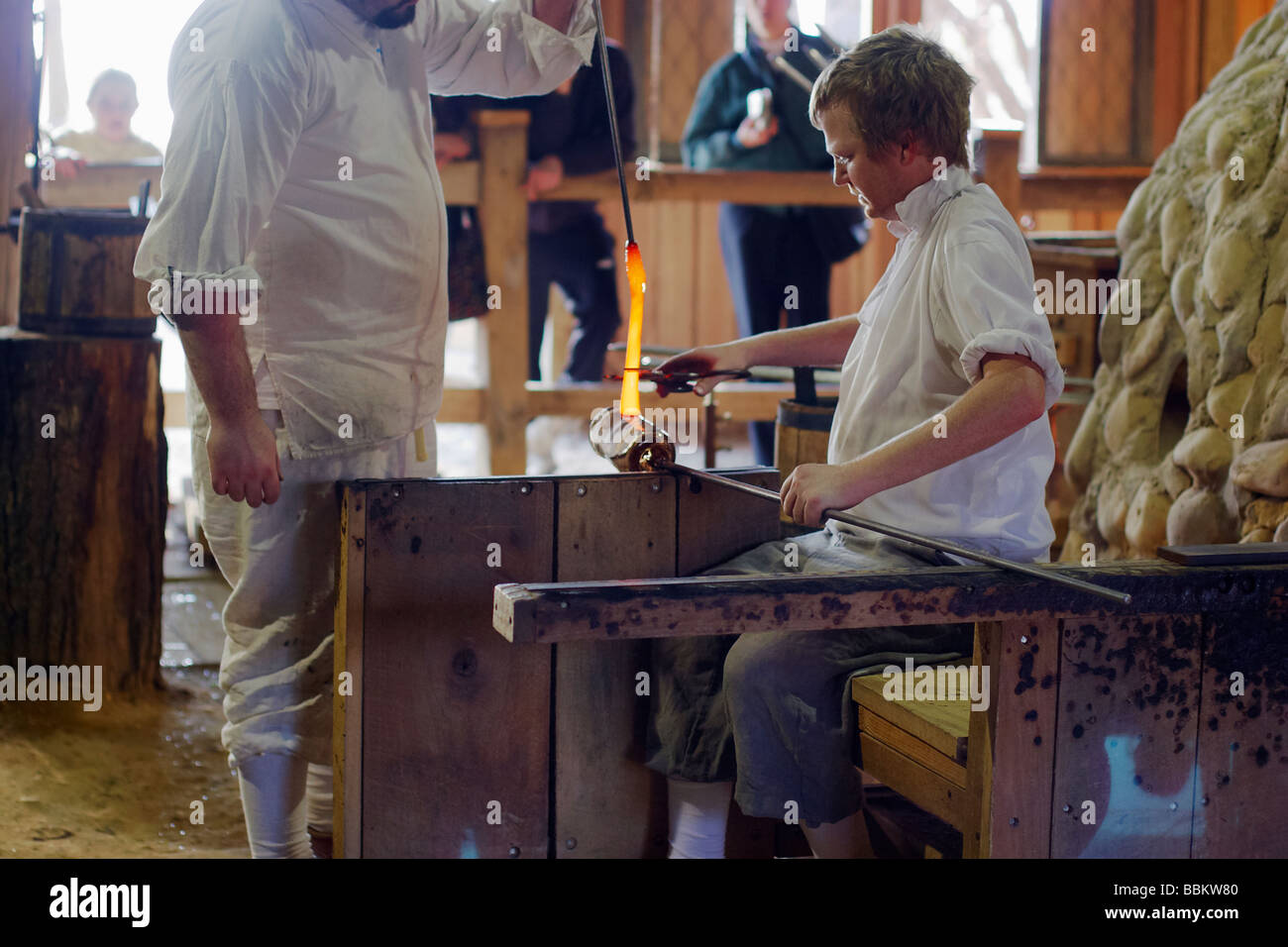 Costumed historical interpreter glassmakers in the Jamestown Glasshouse ...