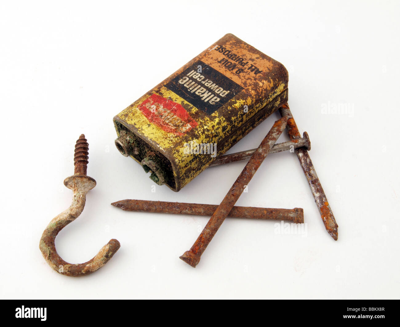Rusty battery with nails and a hook Stock Photo - Alamy
