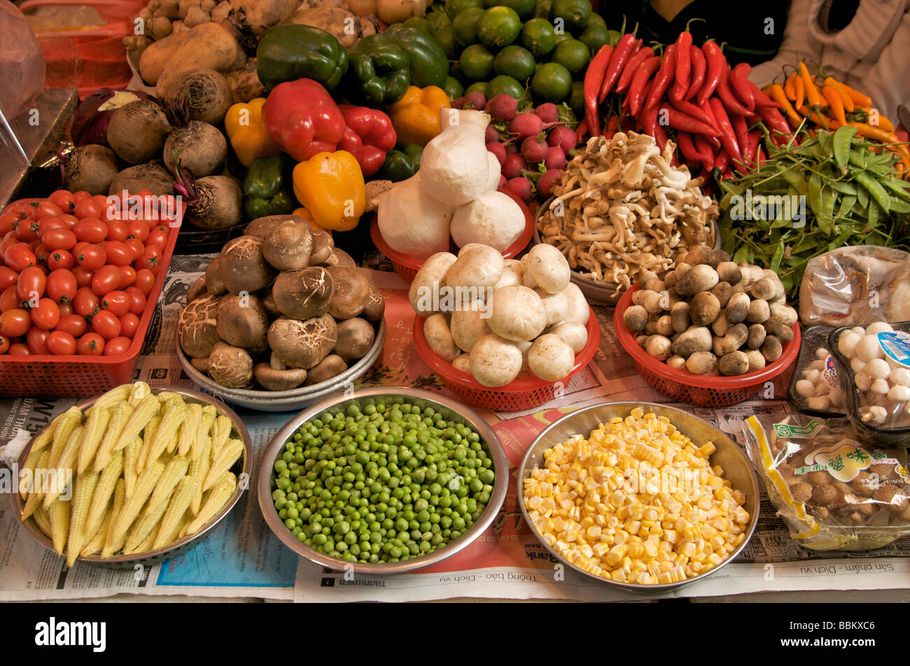 A stall loaded with fresh fruit and vegetables in a Hanoi Street market ...
