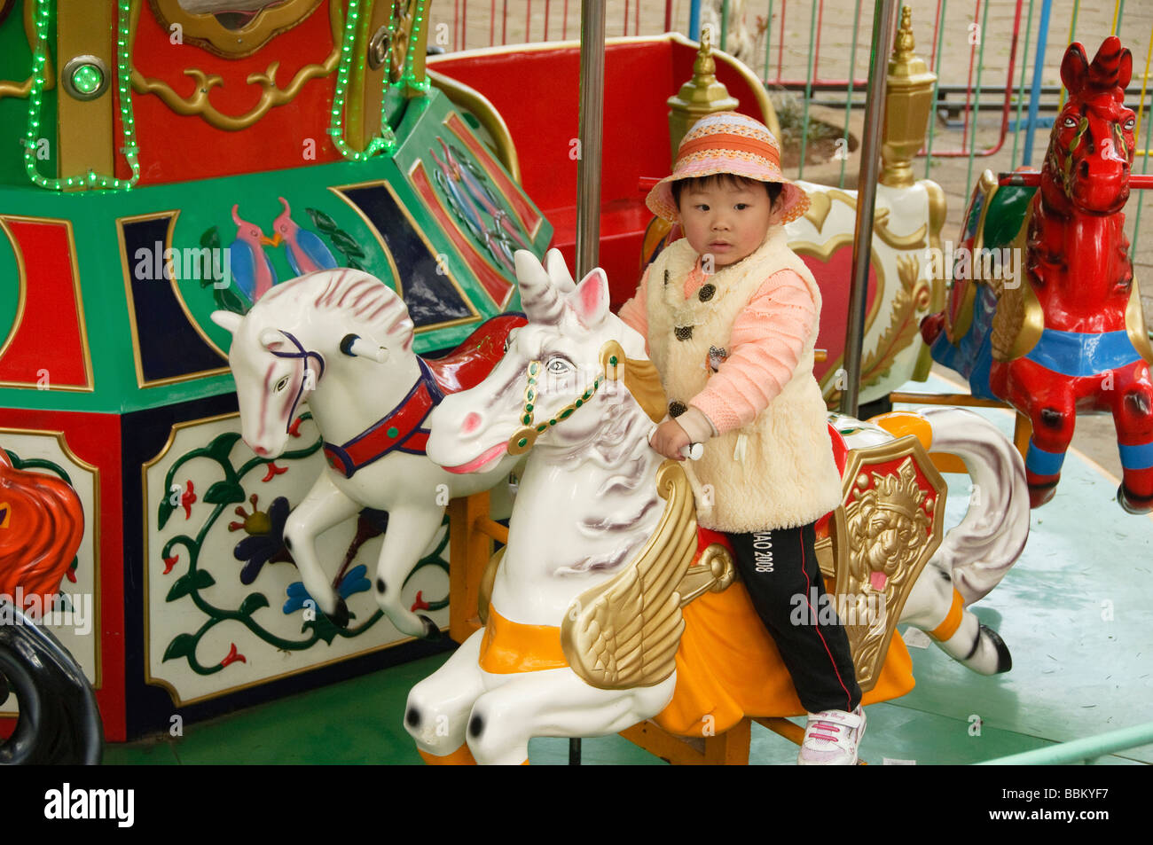 Girl riding on merry go round hi-res stock photography and images - Alamy
