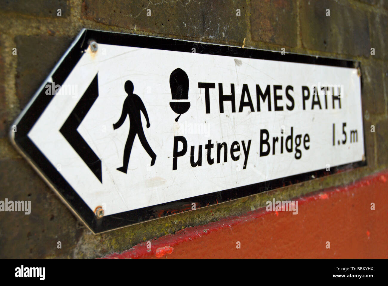 river thames path sign showing direction and distance to putney bridge ...
