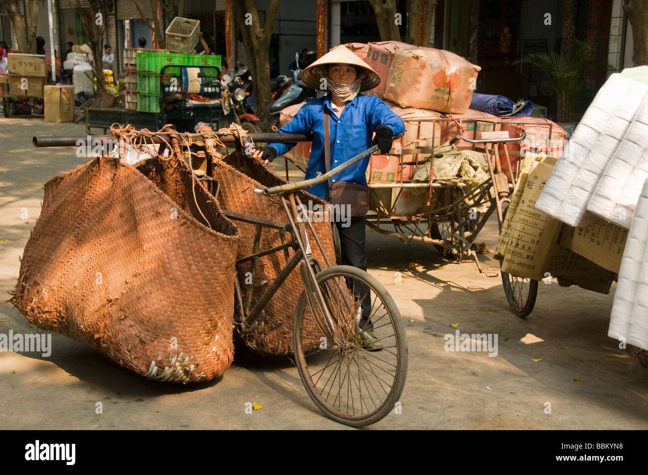 Vietnamese workers transporting goods at the border crossing in Hekou ...
