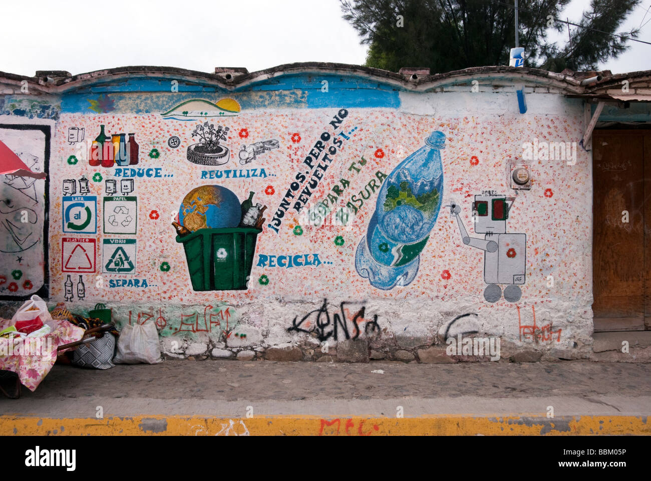 cheerful whimsical hand painted recycling mural on a village wall ...