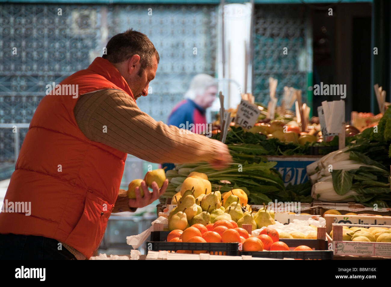 Stall owner setting out pears at the start of the days market Rialto ...