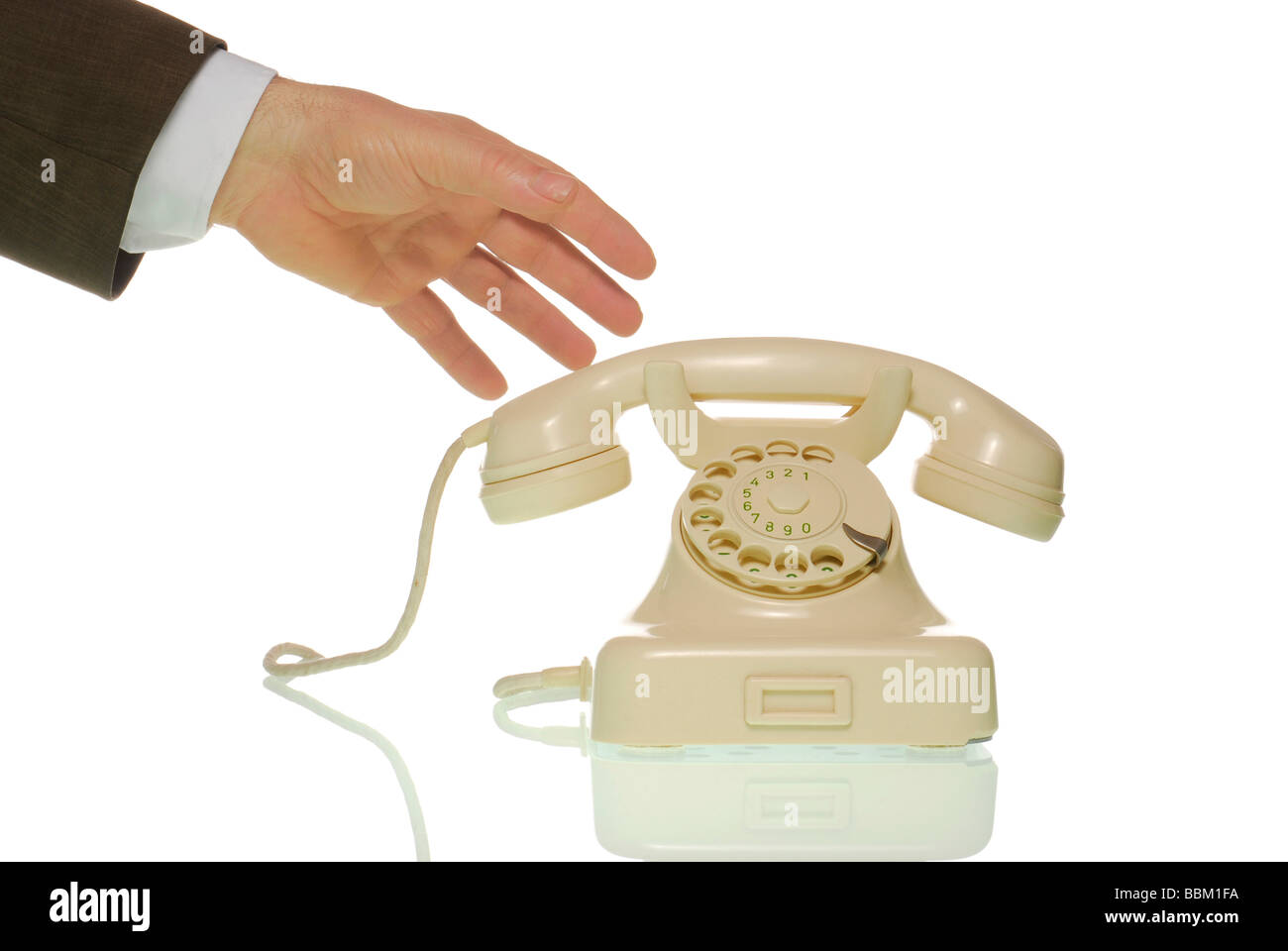 Business man reaching for old-fashioned telephone Stock Photo - Alamy
