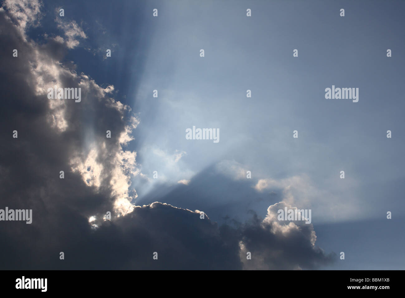 Sun rays through clouds Stock Photo - Alamy