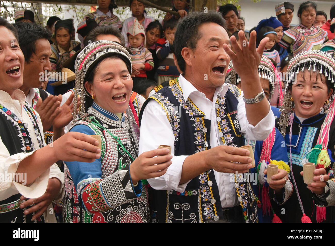Hani Akha women and men singing a toast at the Long Table Festival in ...