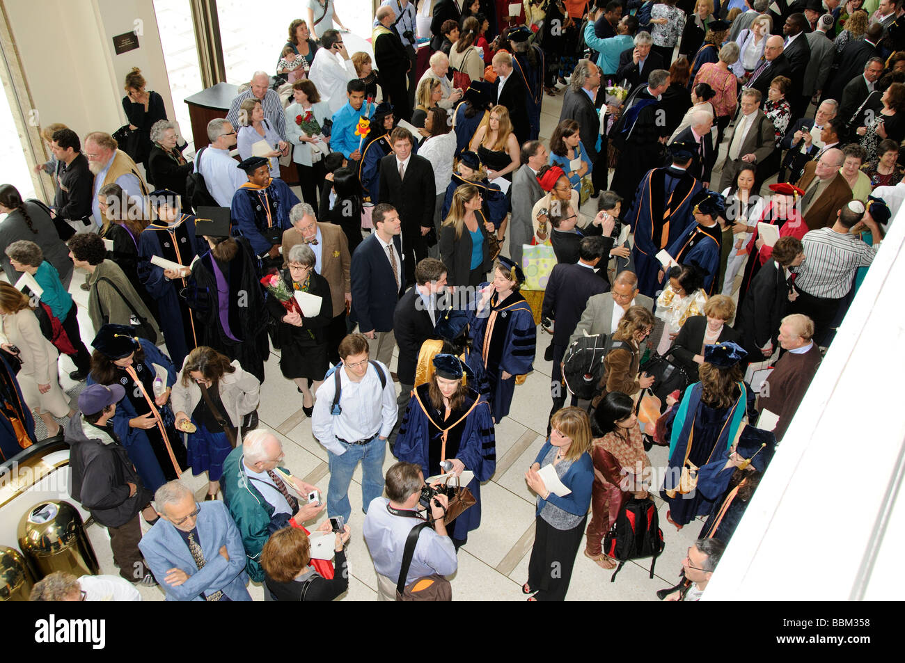 Graduation candidates celebrating with friends and family after ...