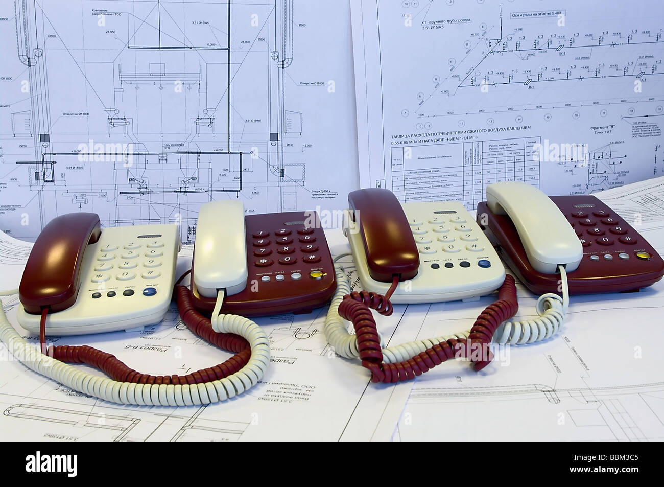 Telephones and project drawings Stock Photo - Alamy