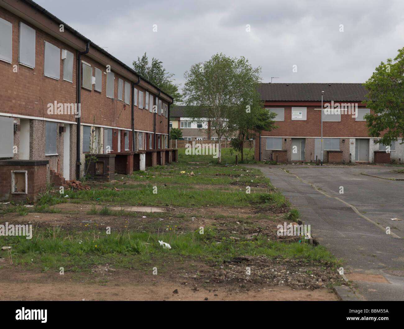 Stack of abandoned houses all boarded up in a desolate housing estate ...