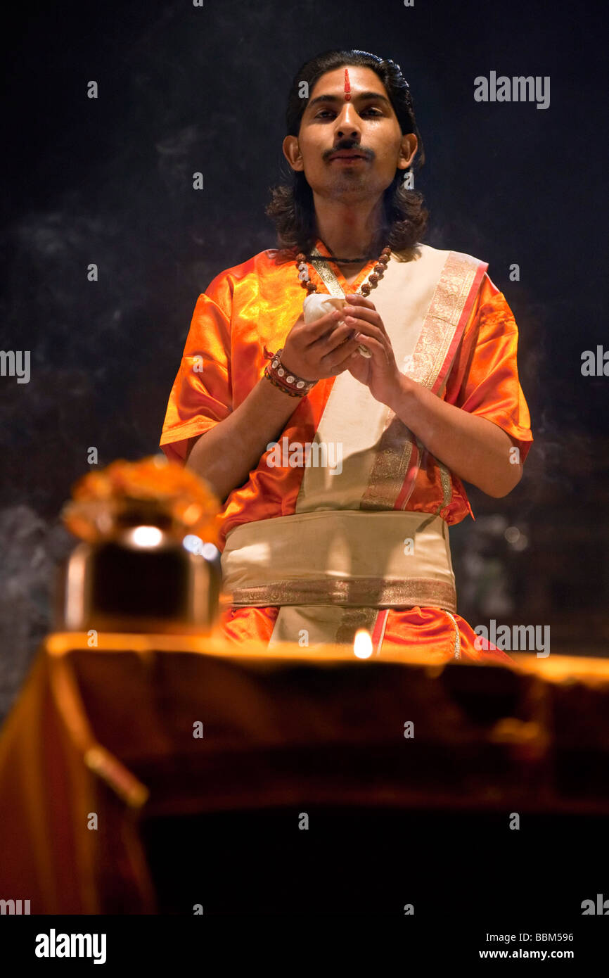 Young Indian male priest performing puja (Agni Pooja) at Dashashwamedh ...