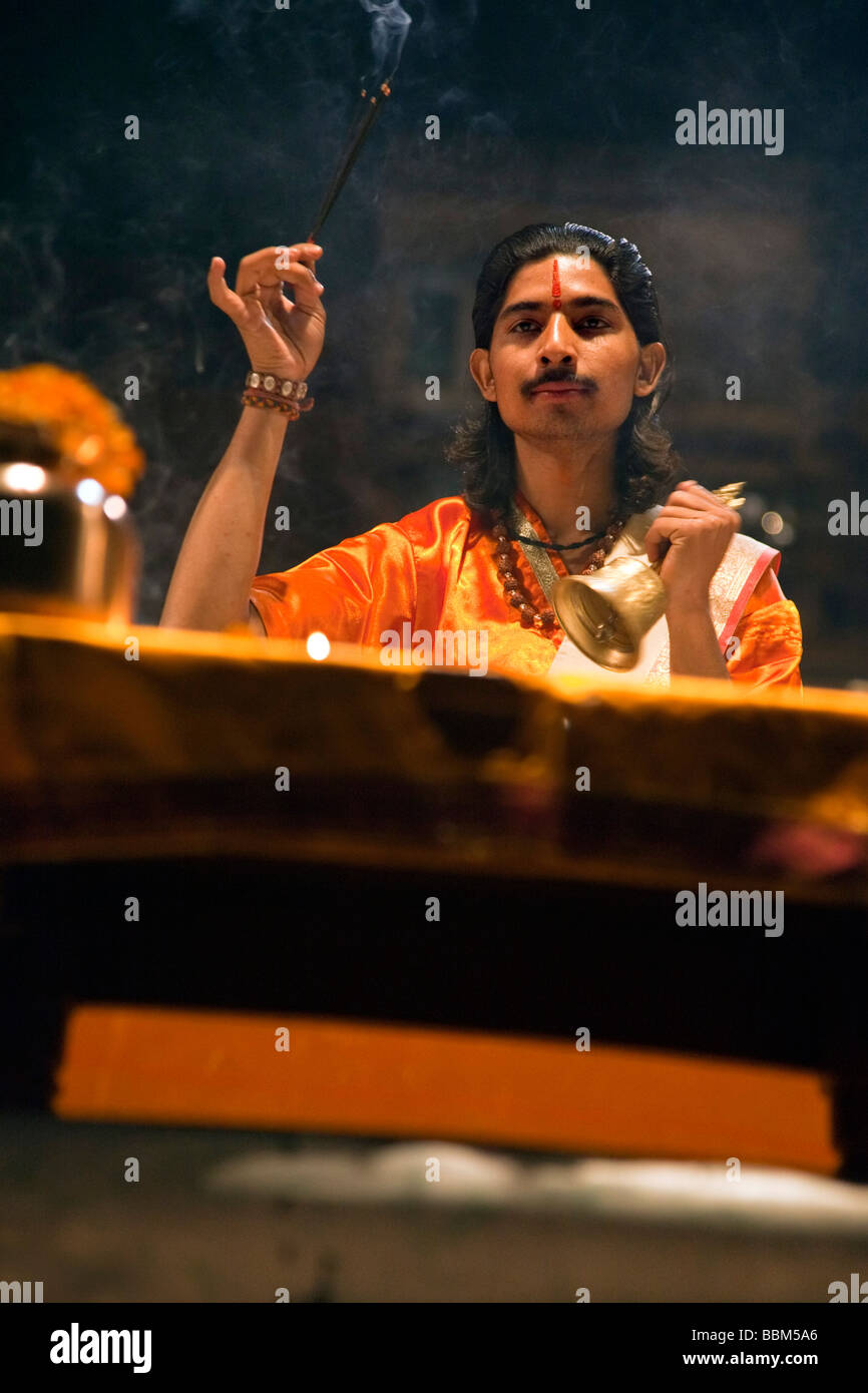 Young Indian male priest performing puja (Agni Pooja) at Dashashwamedh ...