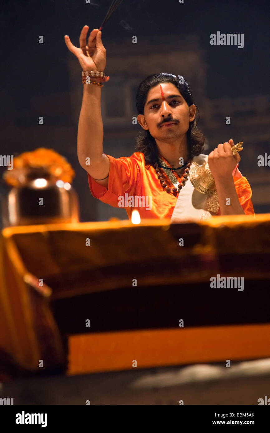 Young Indian male priest performing puja (Agni Pooja) at Dashashwamedh ...