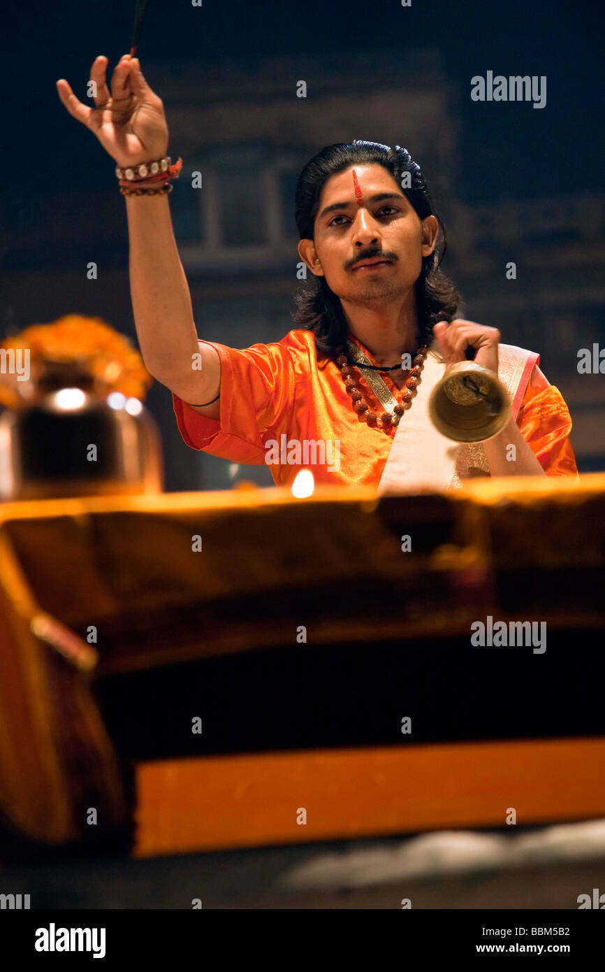 Young Indian male priest performing puja (Agni Pooja) at Dashashwamedh ...