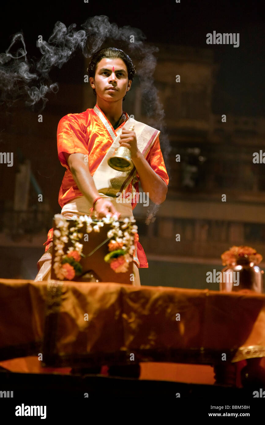 Young Indian male priest performing puja (Agni Pooja) at Dashashwamedh ...