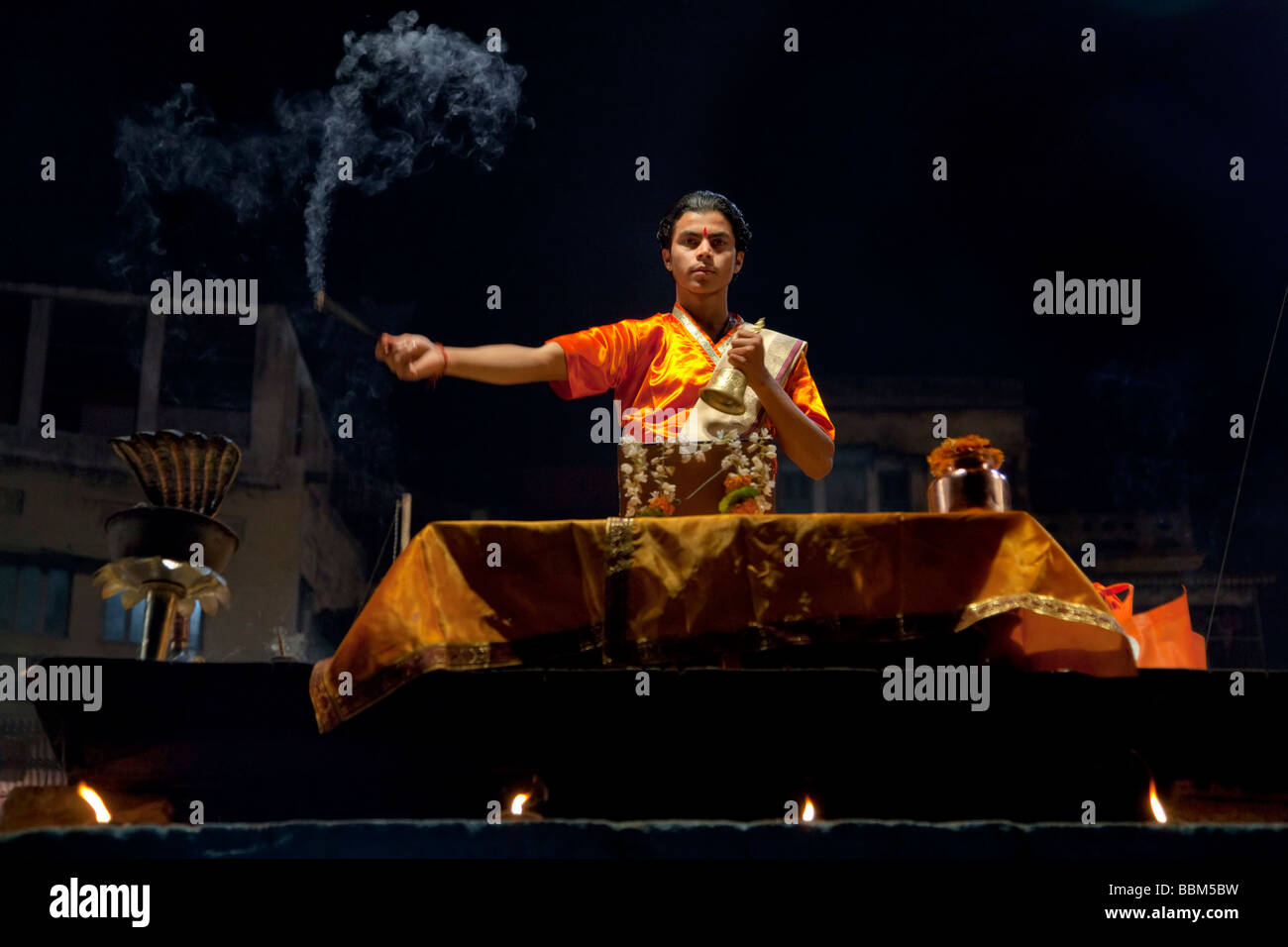 Young Indian male priest performing puja (Agni Pooja) at Dashashwamedh ...