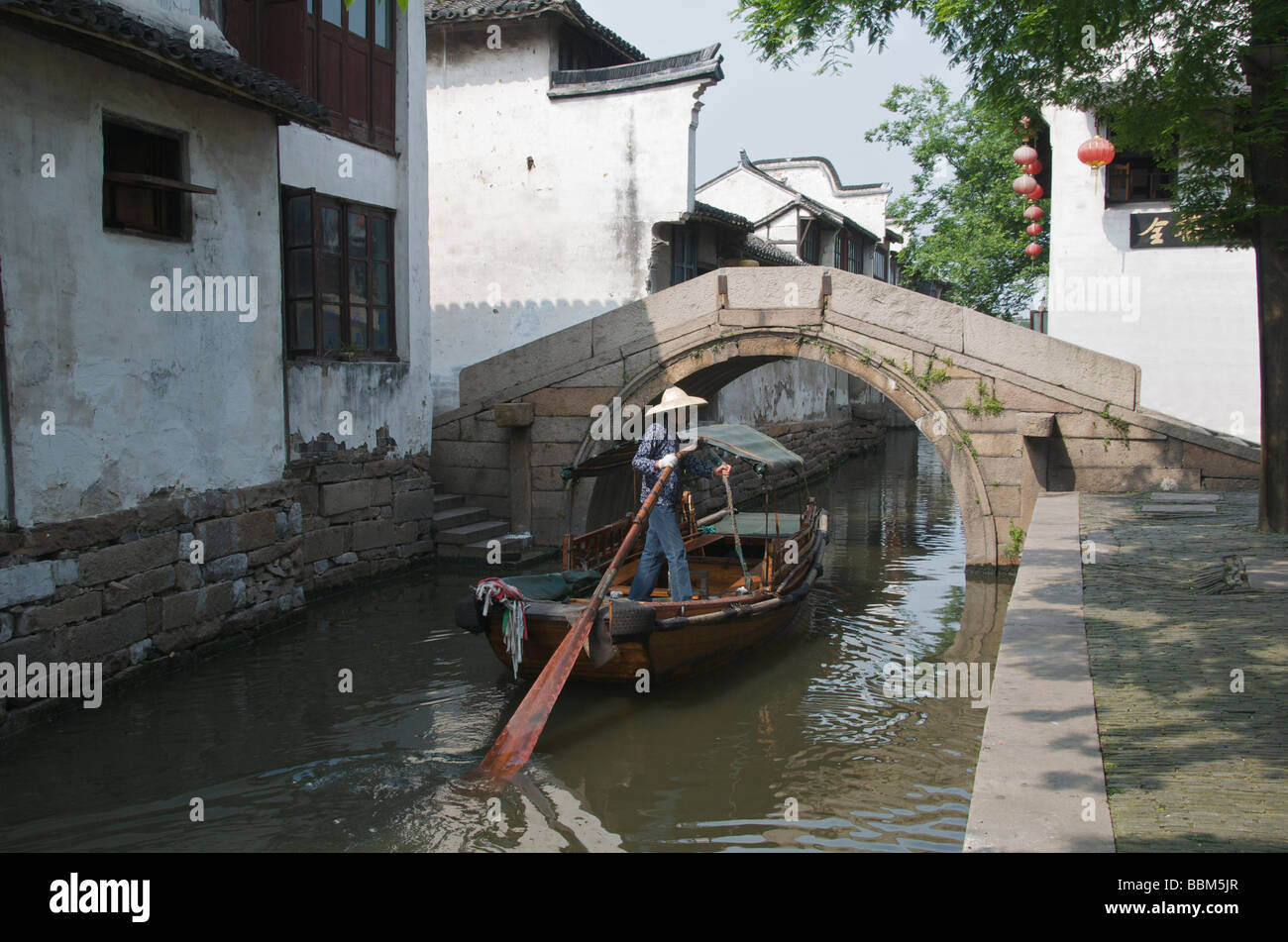 Canal boat and stone bridge in the ancient water town of Zhouzhuang ...