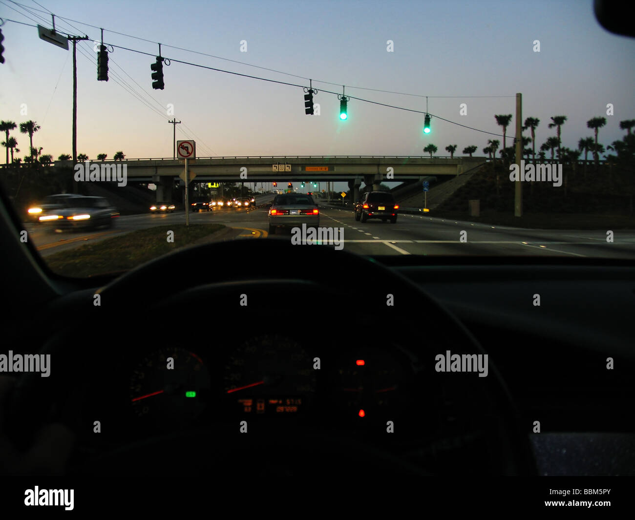 Speeding traffic passing through intersections, at dusk Stock Photo - Alamy
