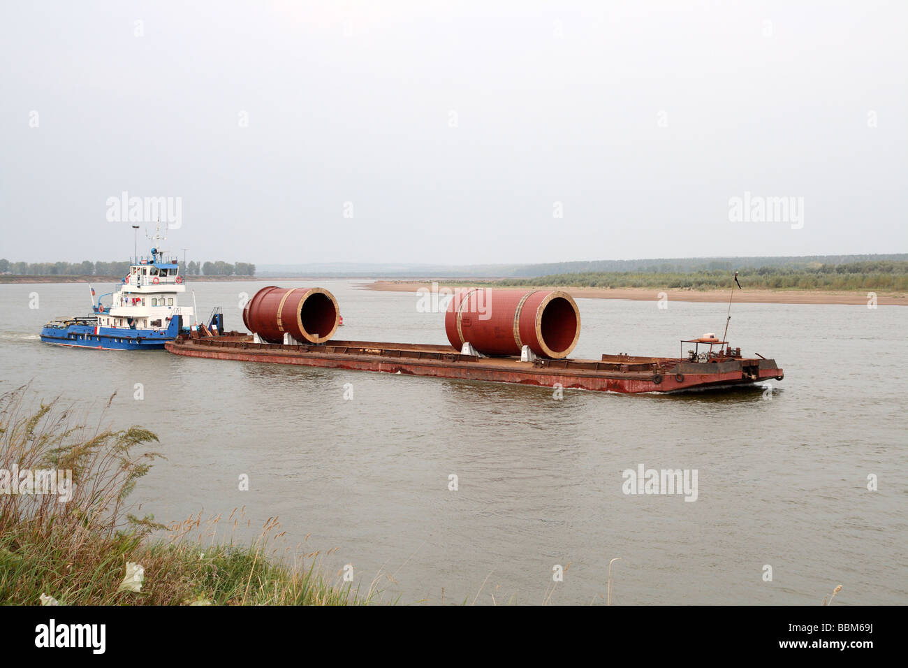 industrial cargo transportation on river by ship with barge Stock Photo ...