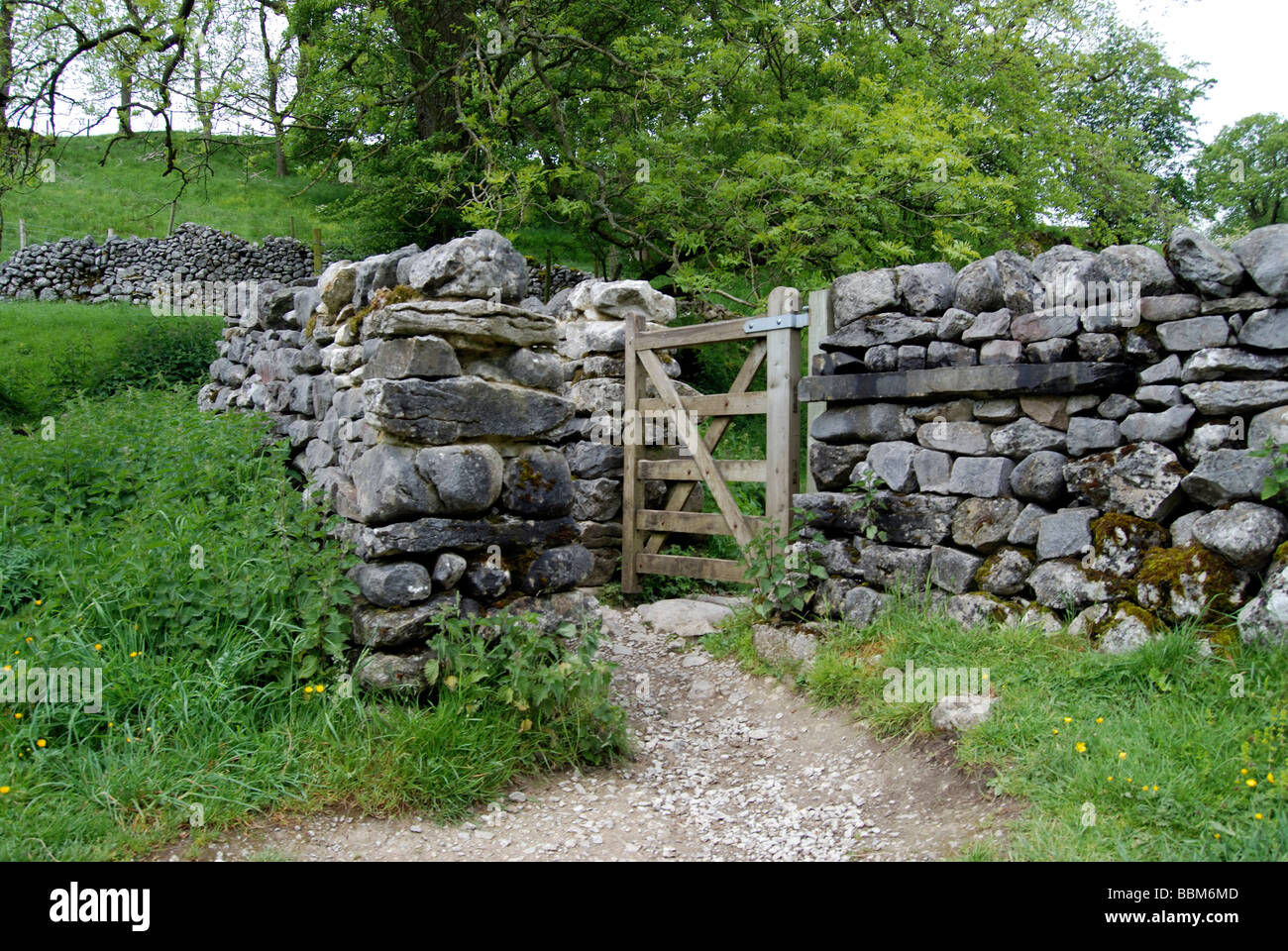 A gate in a dry stone wall near Malham Village in the Yorkshire Dales ...