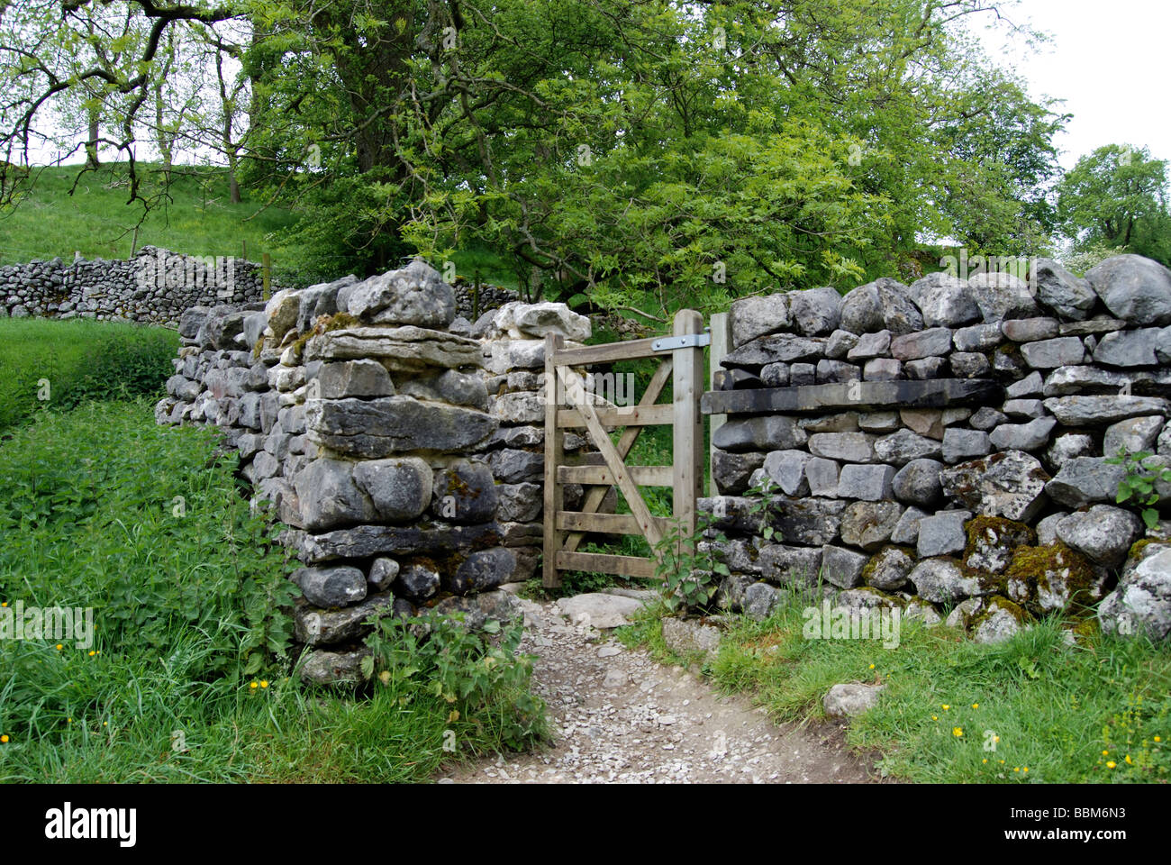 A gate in a dry stone wall near Malham Village in the Yorkshire Dales ...