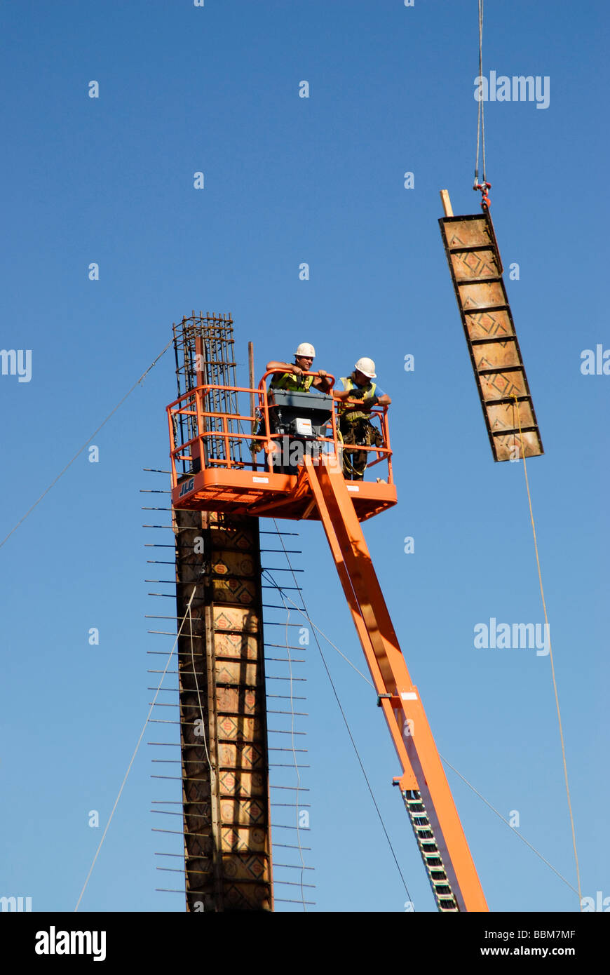 workers assembling forms on a column in a construction site Stock Photo ...