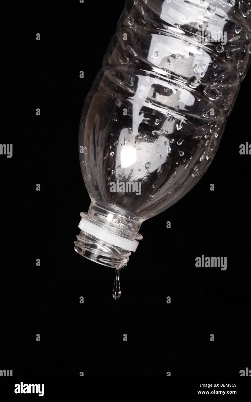 Last drop of water dripping from empty plastic water bottle Stock Photo ...