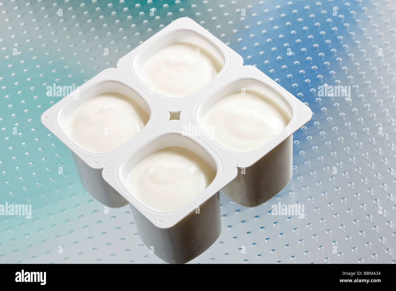 Four tubs of yoghurt Stock Photo - Alamy