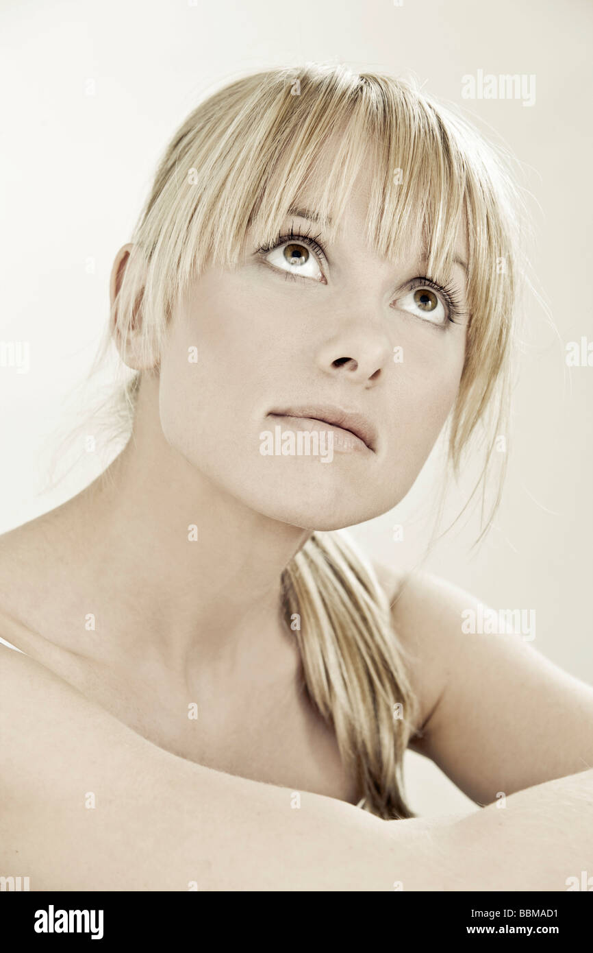 Pretty young woman looking up Stock Photo - Alamy