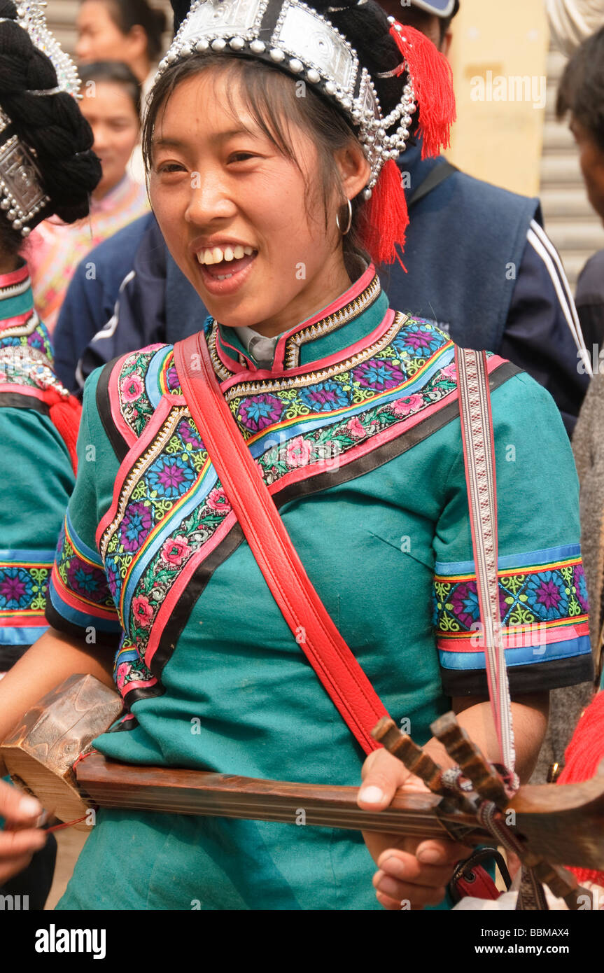 Hani woman playing local instruments at the Long Table Festival in ...