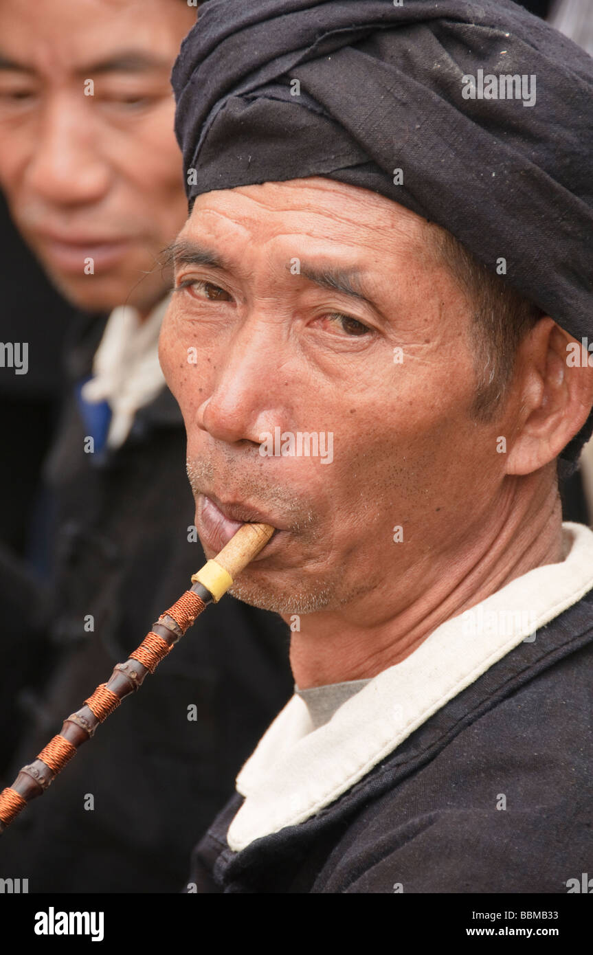 Hani Akha headman having a pipe smoke at the Long Table Festival in ...