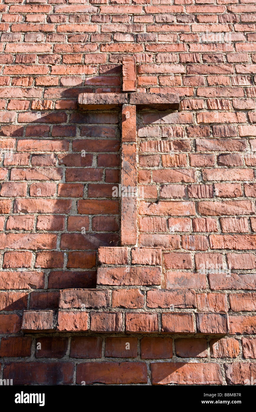 Christian cross on red brick wall Stock Photo - Alamy