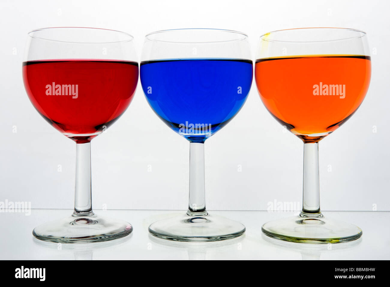 Three glasses with color drinks isolated on white Stock Photo - Alamy