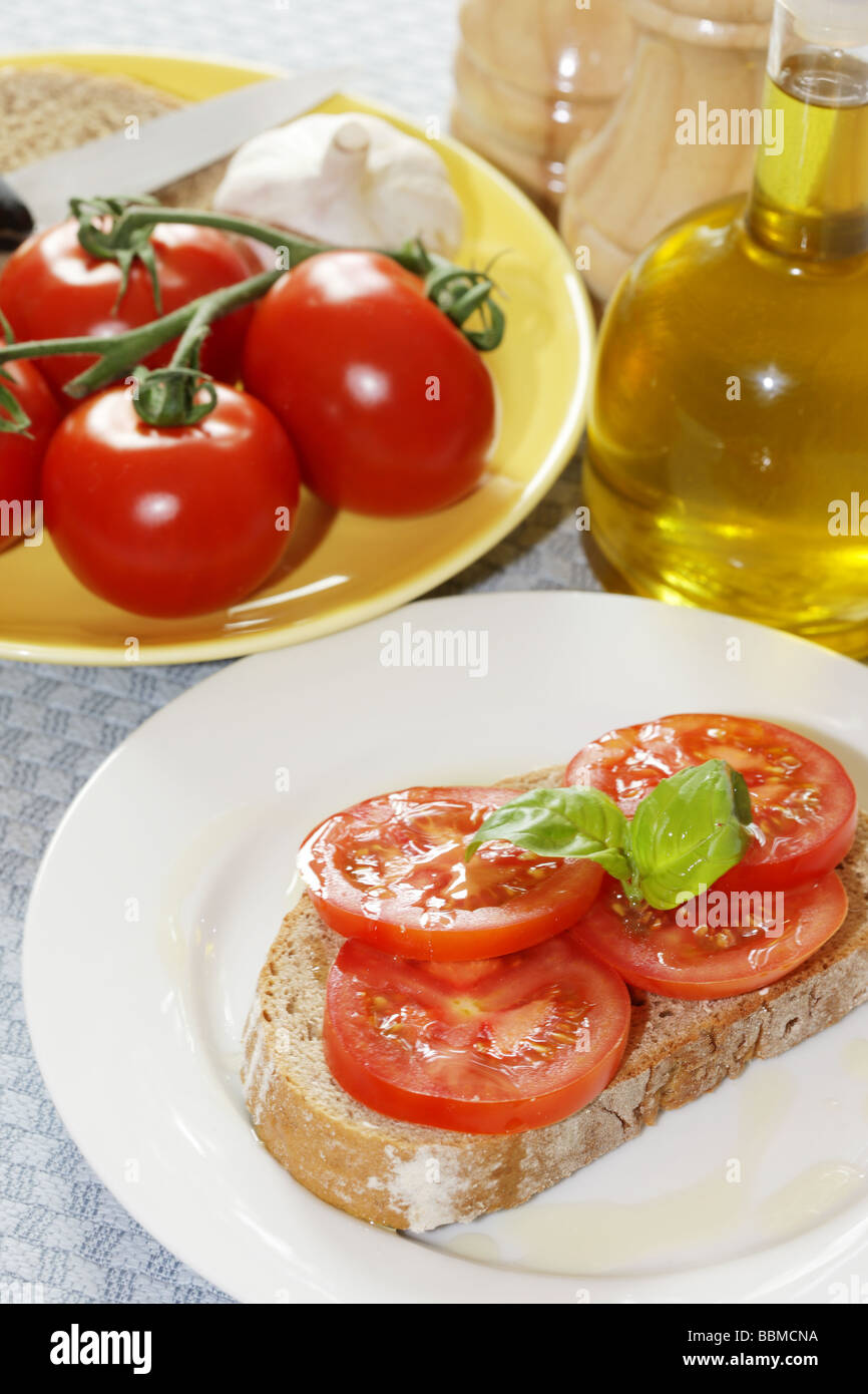 Sliced Tomato with Basil on Sourdough Bread Stock Photo - Alamy