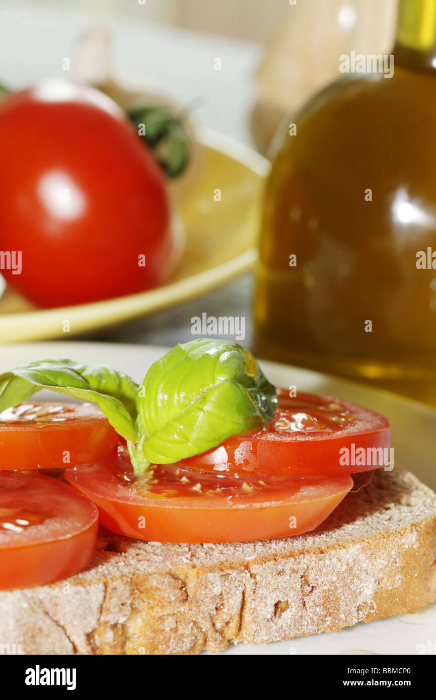Sliced Tomato with Basil on Sourdough Bread Stock Photo - Alamy
