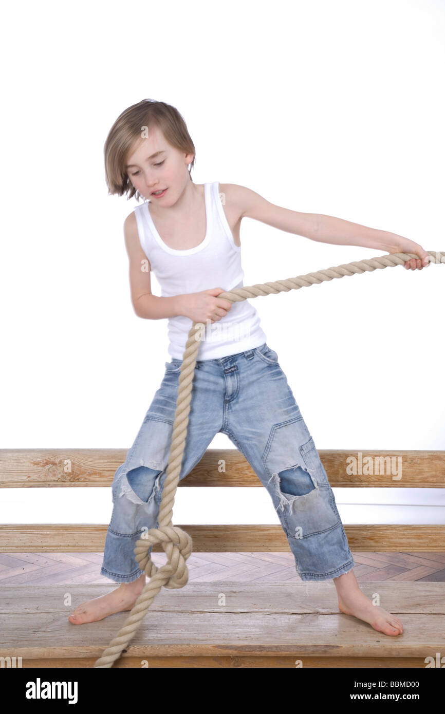 Boy pulling a rope Stock Photo - Alamy