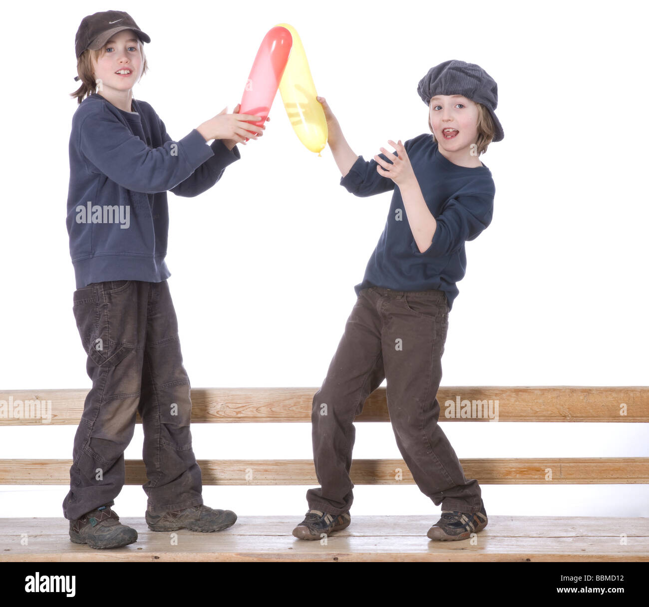 Two boys wearing caps, playing with balloons Stock Photo - Alamy