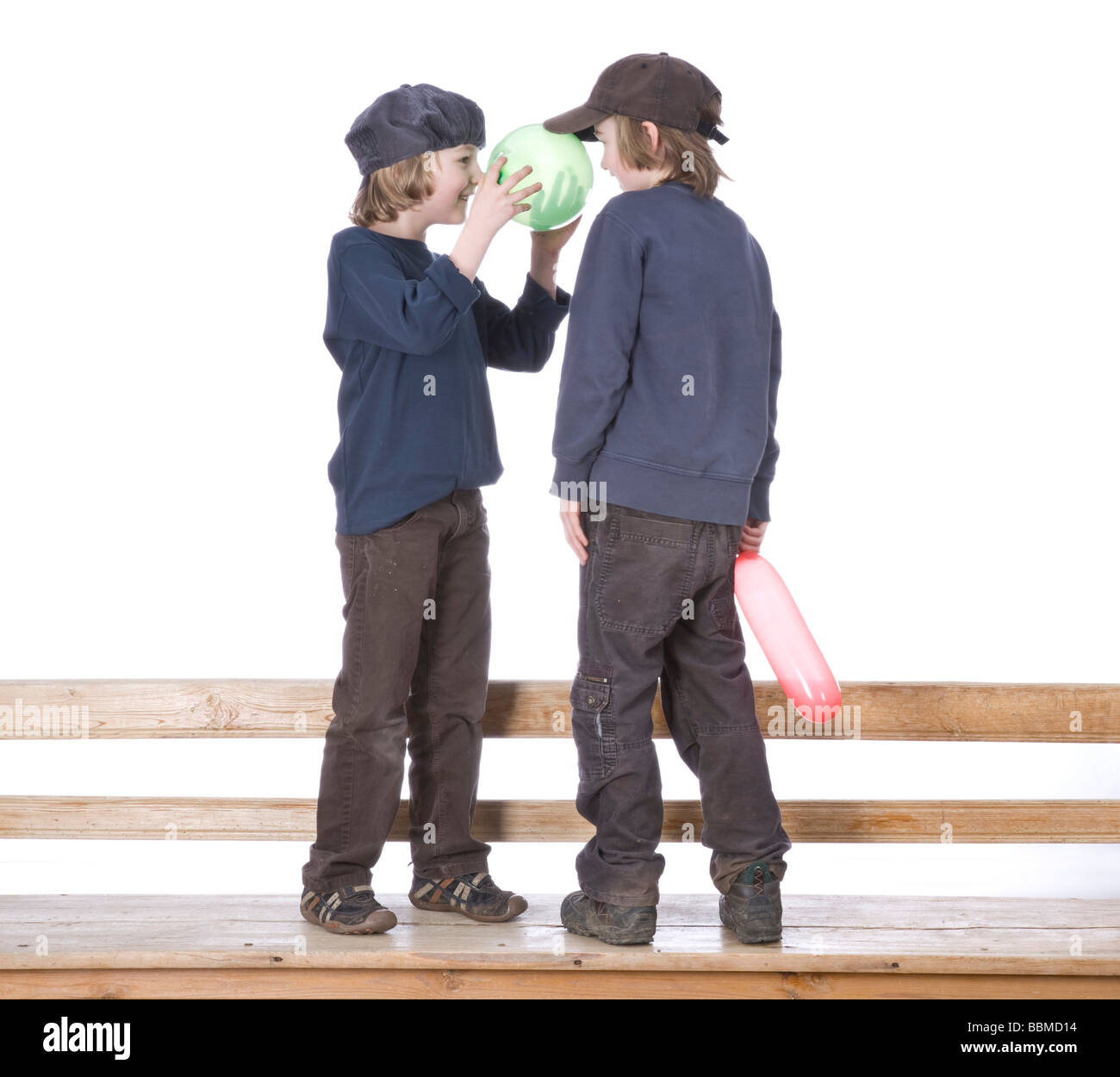 Two boys wearing caps, playing with balloons Stock Photo - Alamy