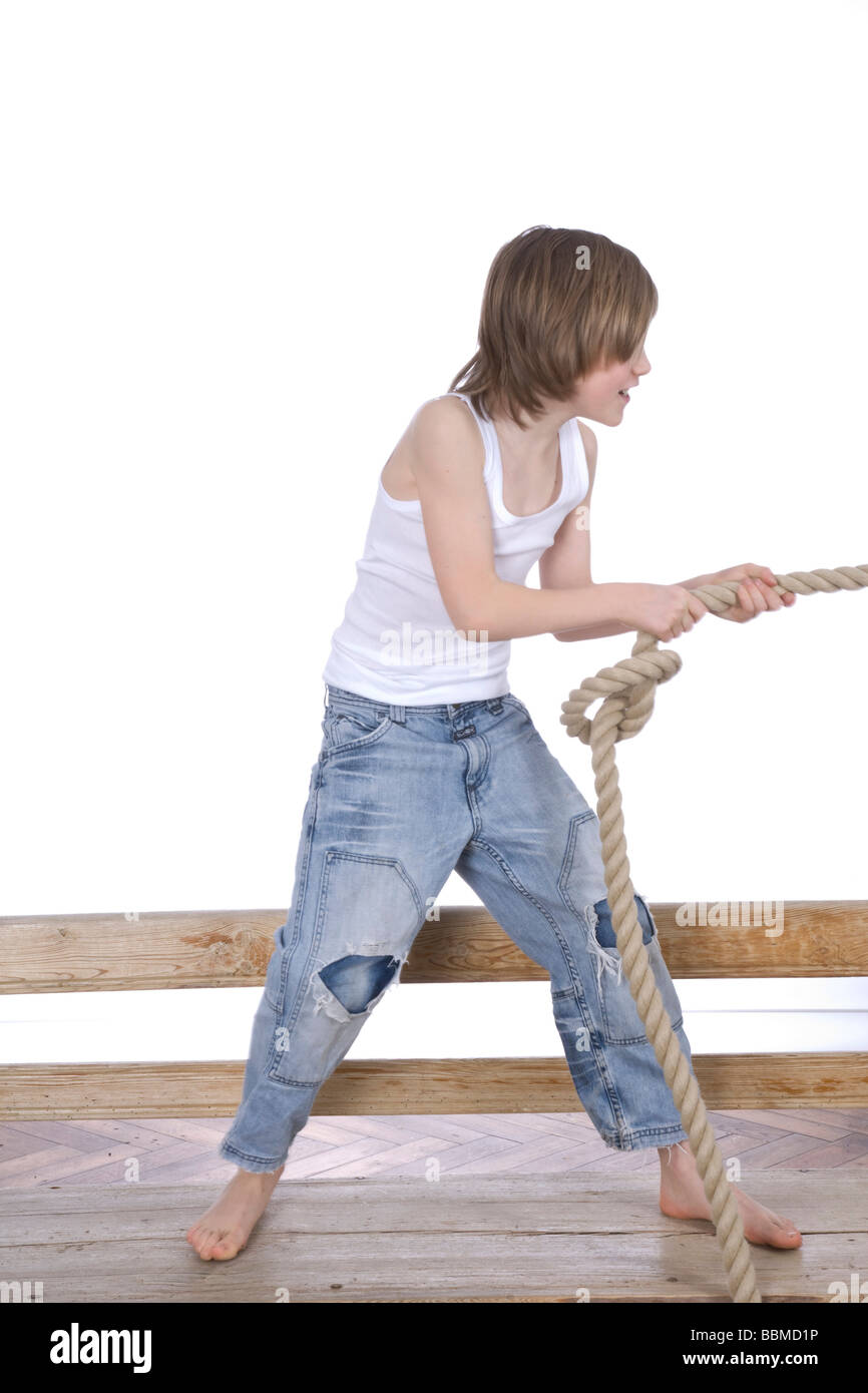 Boy pulling a rope Stock Photo - Alamy